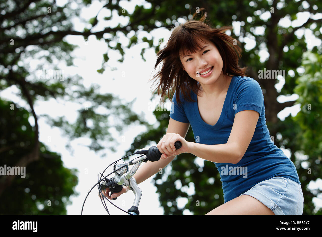 Young woman riding bike Stock Photo - Alamy