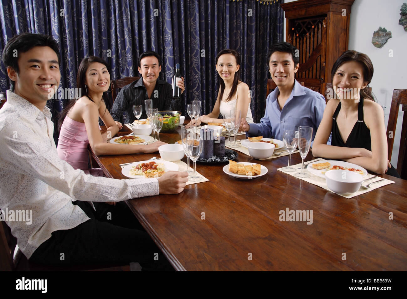 Couples at home around dinner table hi-res stock photography and images ...