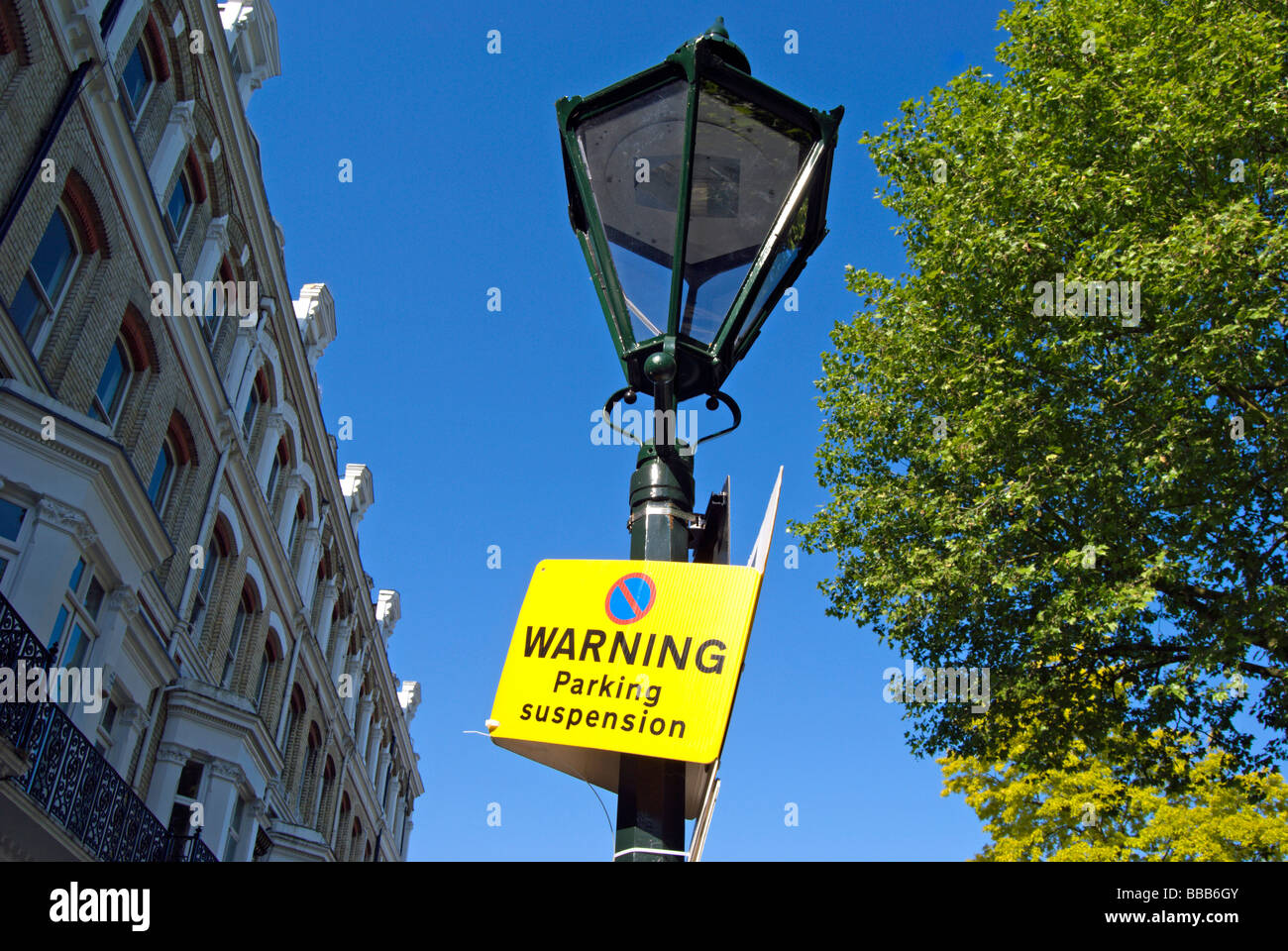 victorian style lamppost with parking suspension warning sign, seen ...