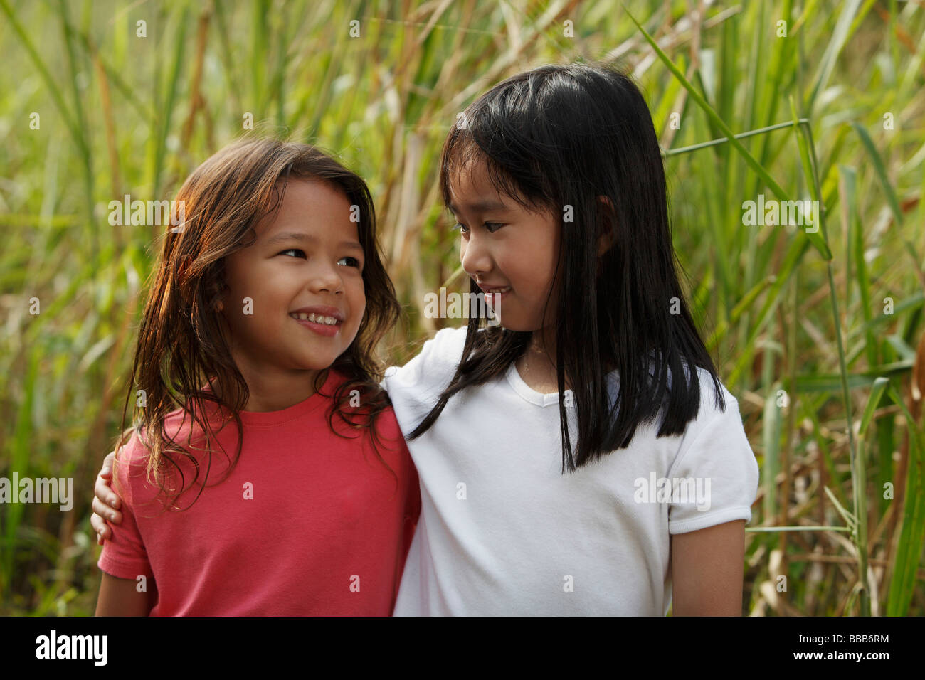 Two girls looking at each other Stock Photo - Alamy