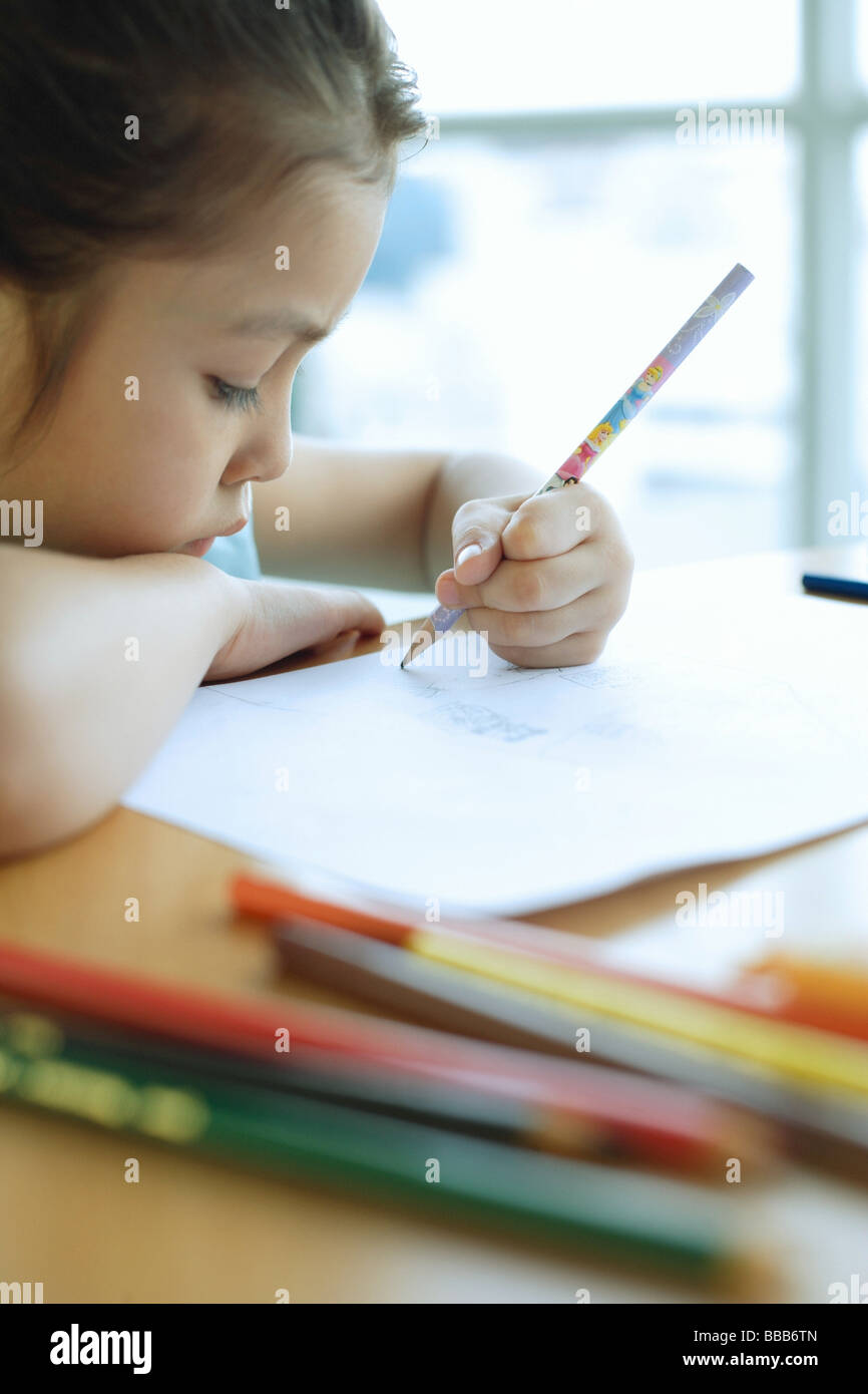 Young girl drawing, resting chin on arm Stock Photo - Alamy