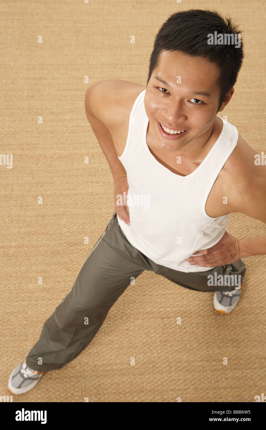 Man standing with legs apart, hands on hip, looking at camera Stock ...