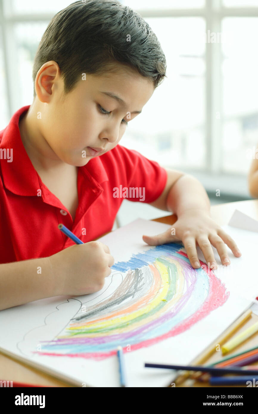 Boy holding colour pencil, drawing Stock Photo - Alamy