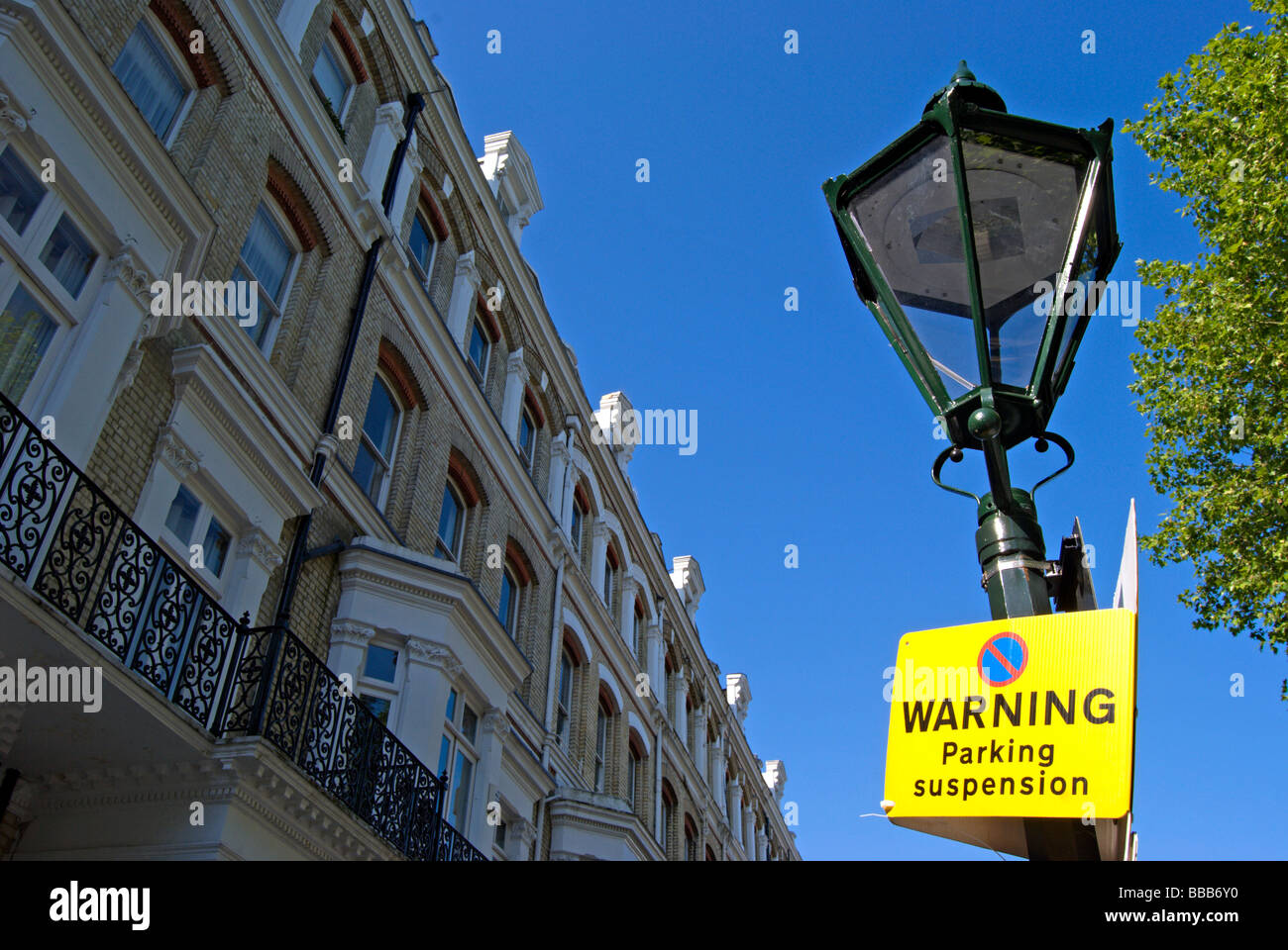 victorian style lamppost with parking suspension warning sign, seen ...