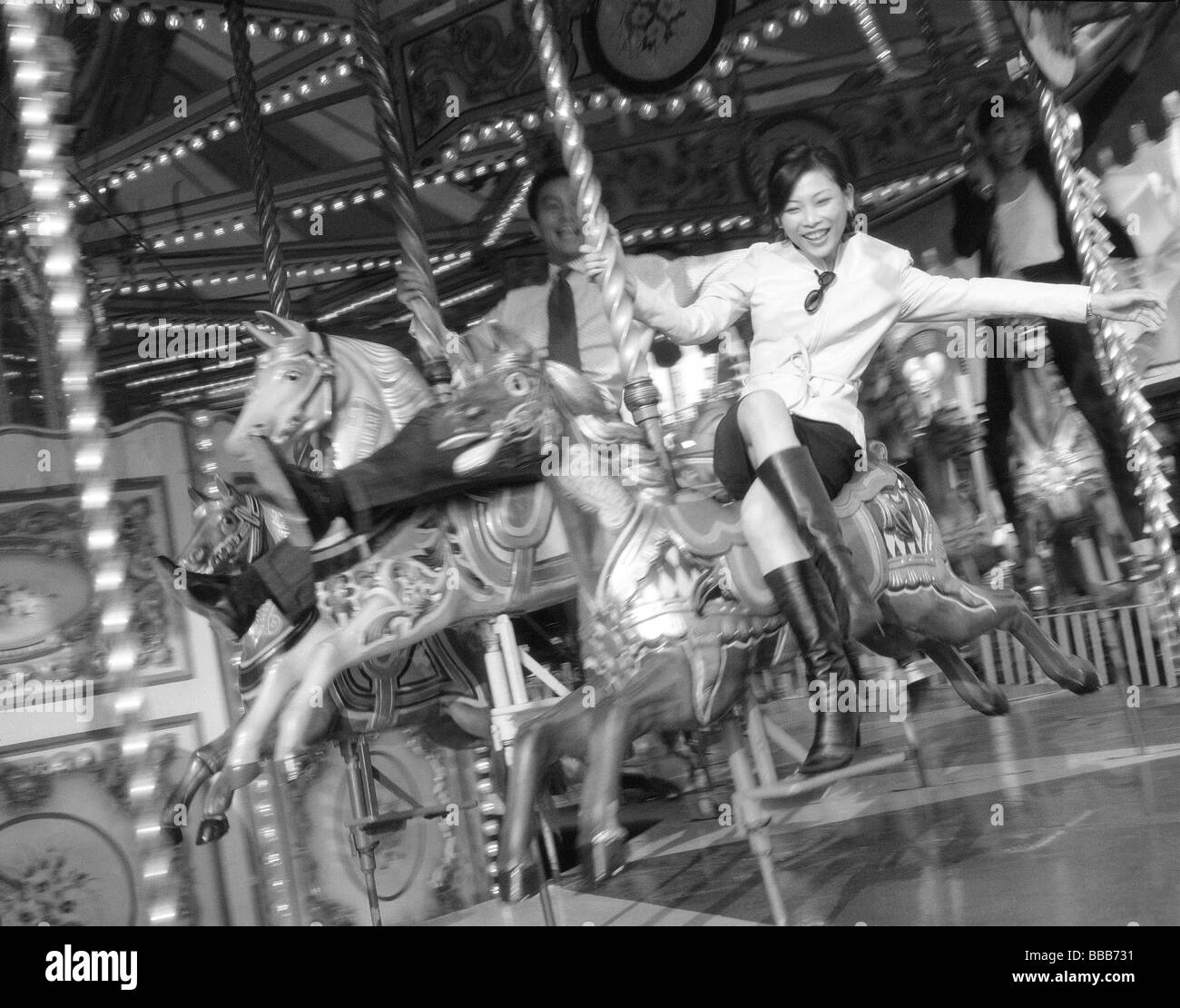 Woman sitting horse on carousel hi-res stock photography and images - Alamy