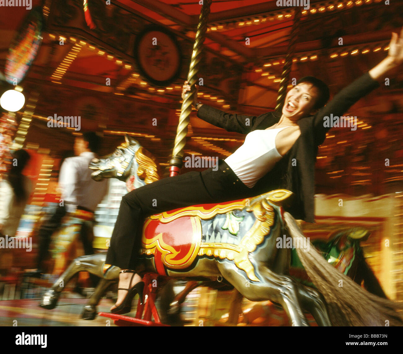 Woman riding horse on carousel Stock Photo - Alamy