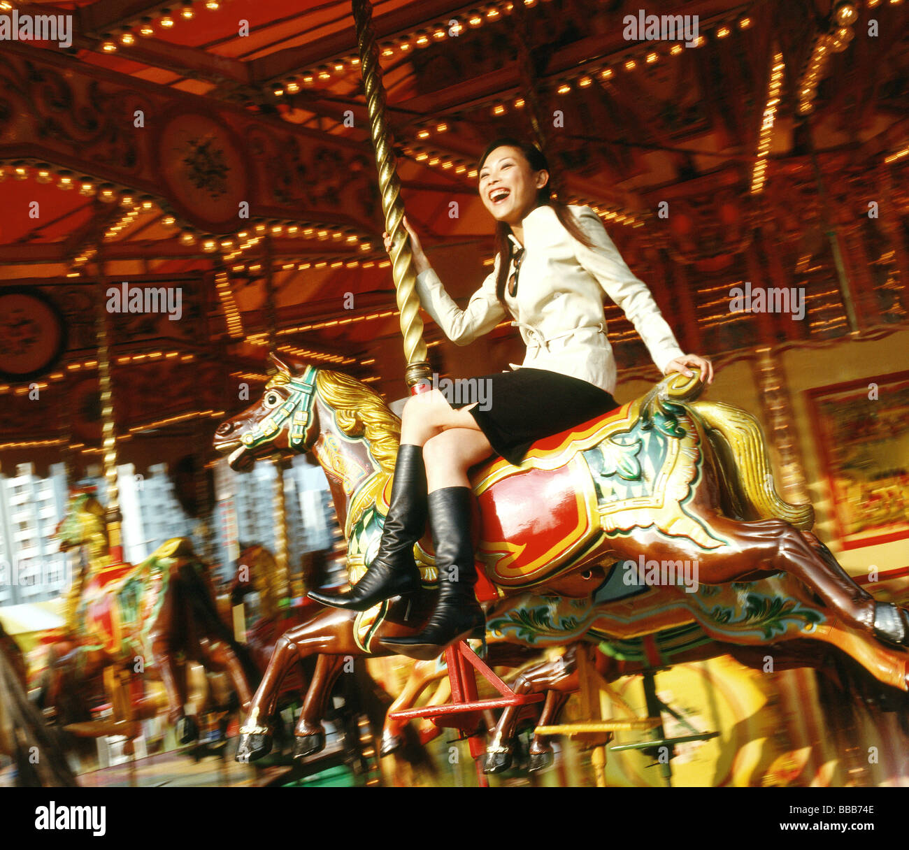 Women riding on carousel hi-res stock photography and images - Alamy