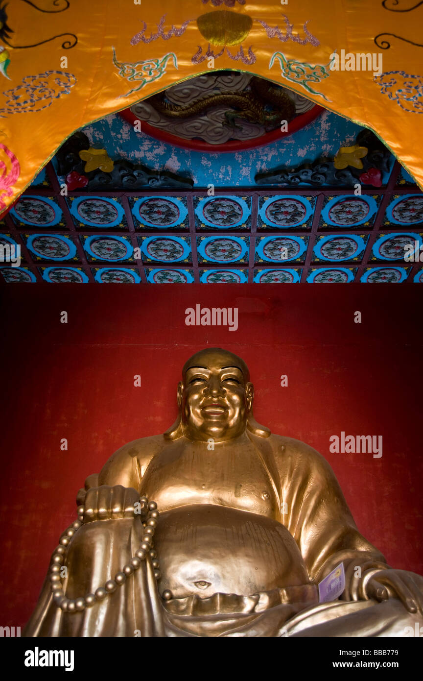 Golden statue of smiling buddha Stock Photo - Alamy