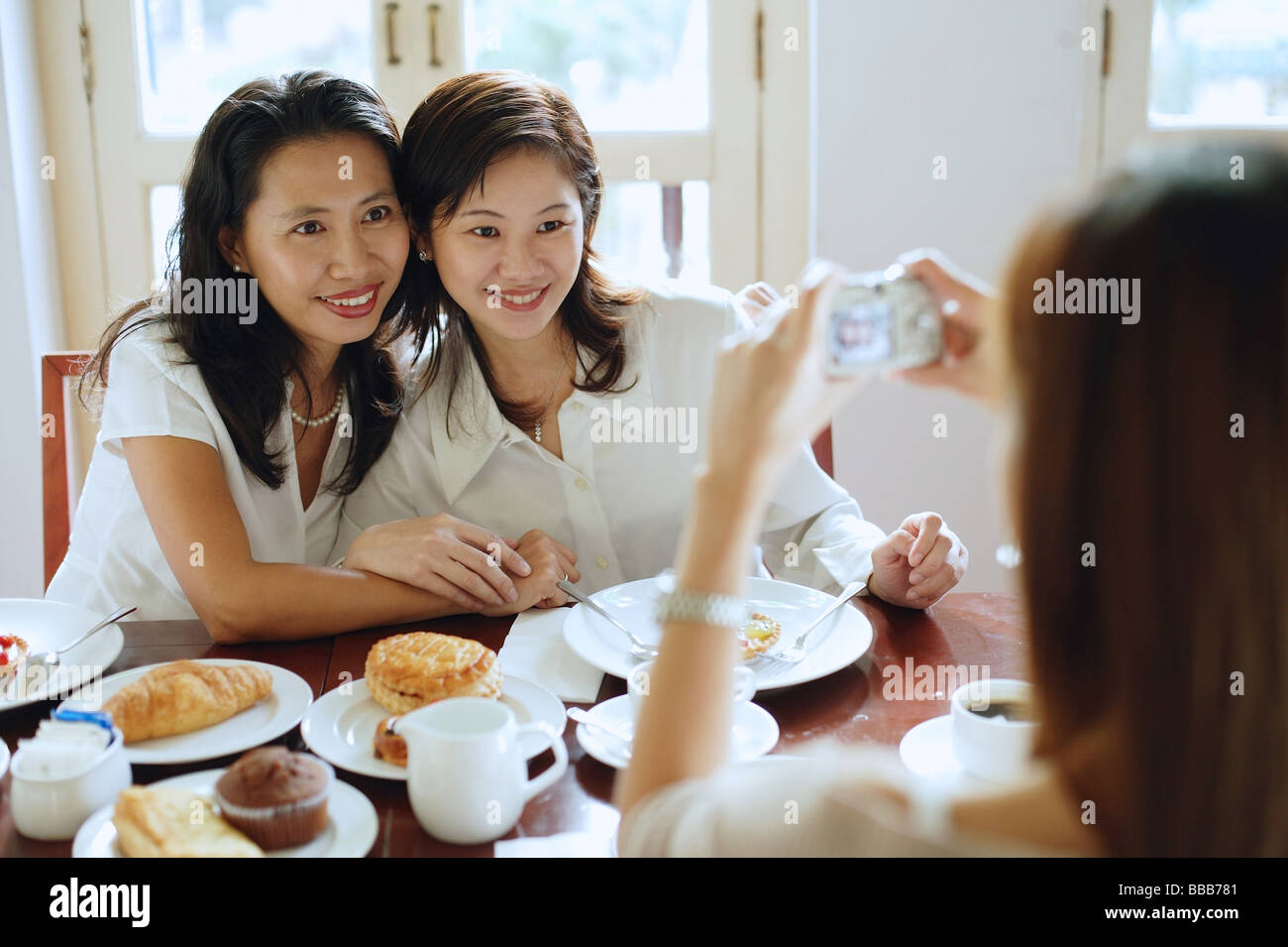 Women in cafe, posing for photograph Stock Photo - Alamy