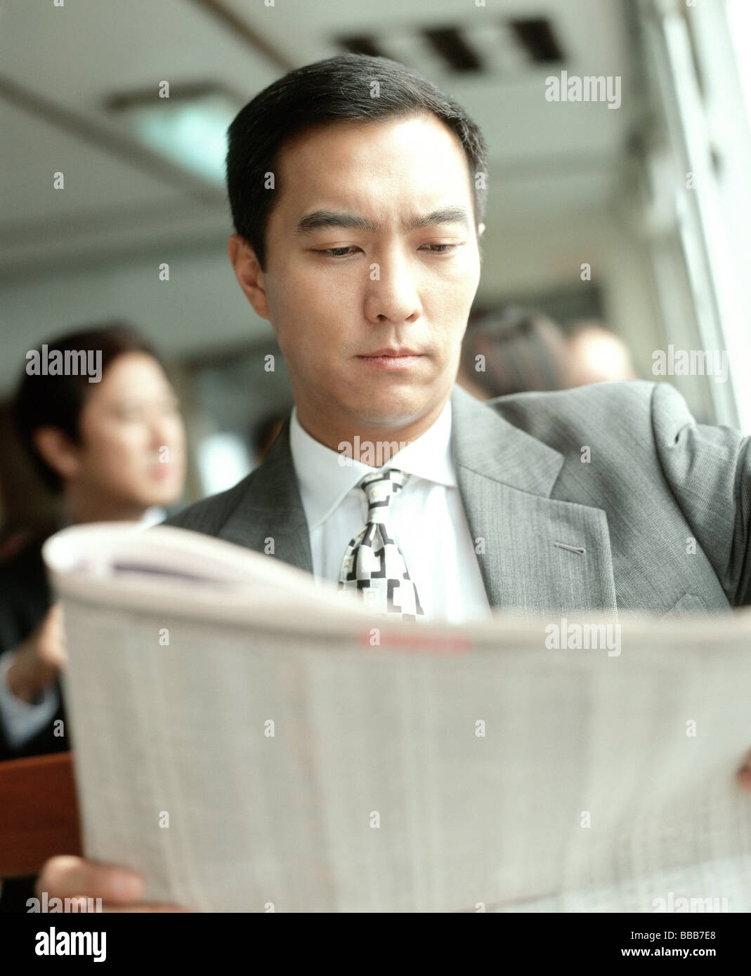 Male executive reading newspaper Stock Photo - Alamy