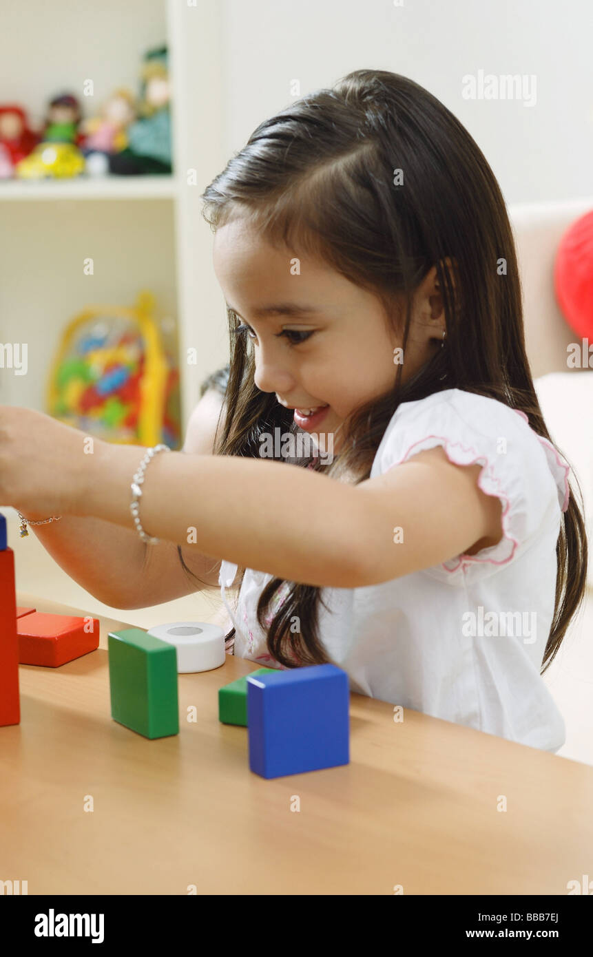 Girl playing with building blocks Stock Photo - Alamy