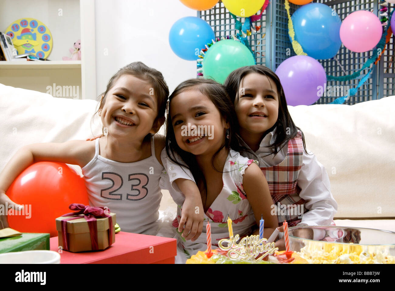 Children at a birthday party, looking at camera, smiling Stock Photo ...