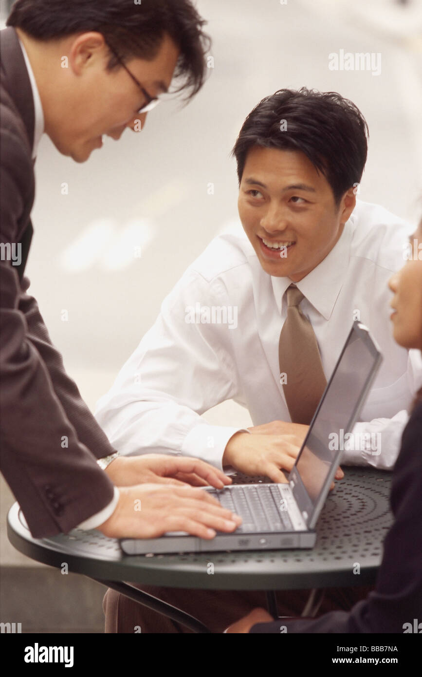 Executives working on laptop computer Stock Photo - Alamy