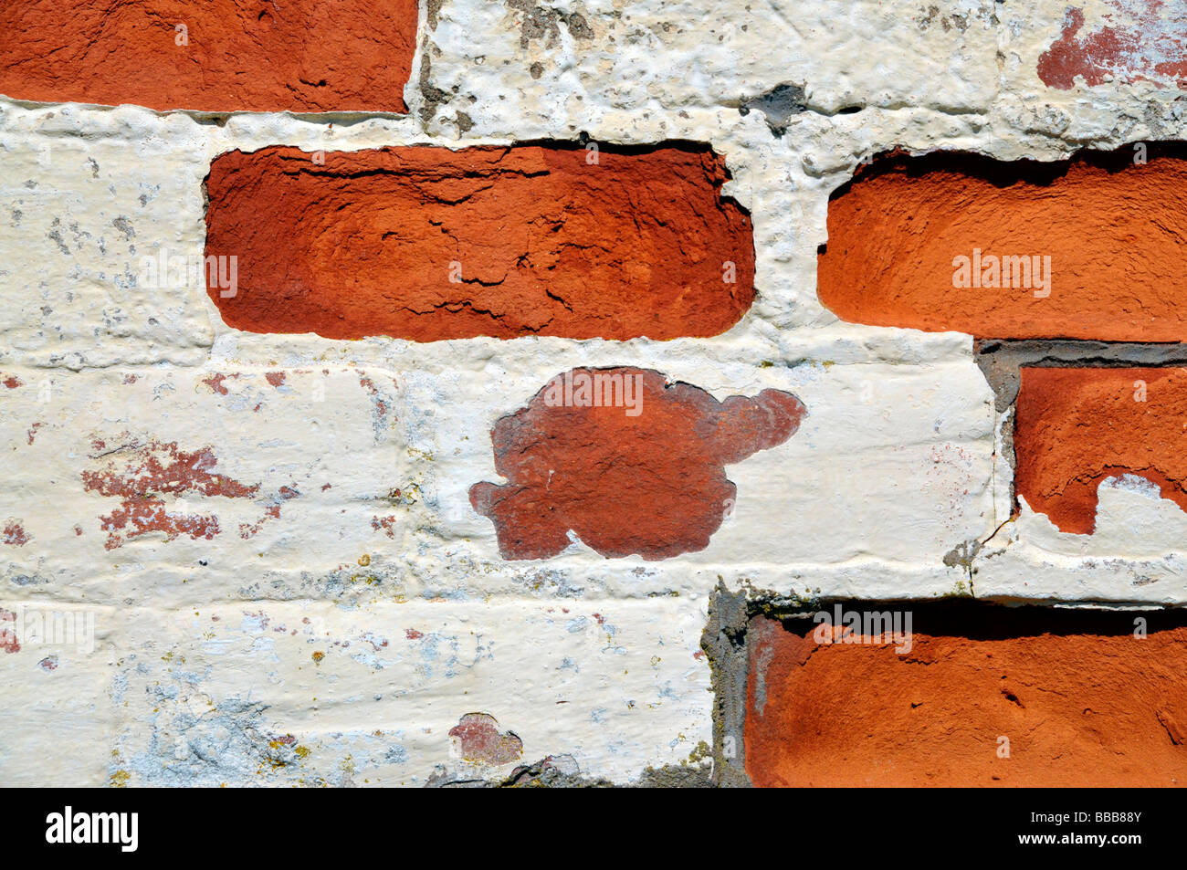 Peeling whitewashed plaster revealing red bricks beneath Stock Photo ...