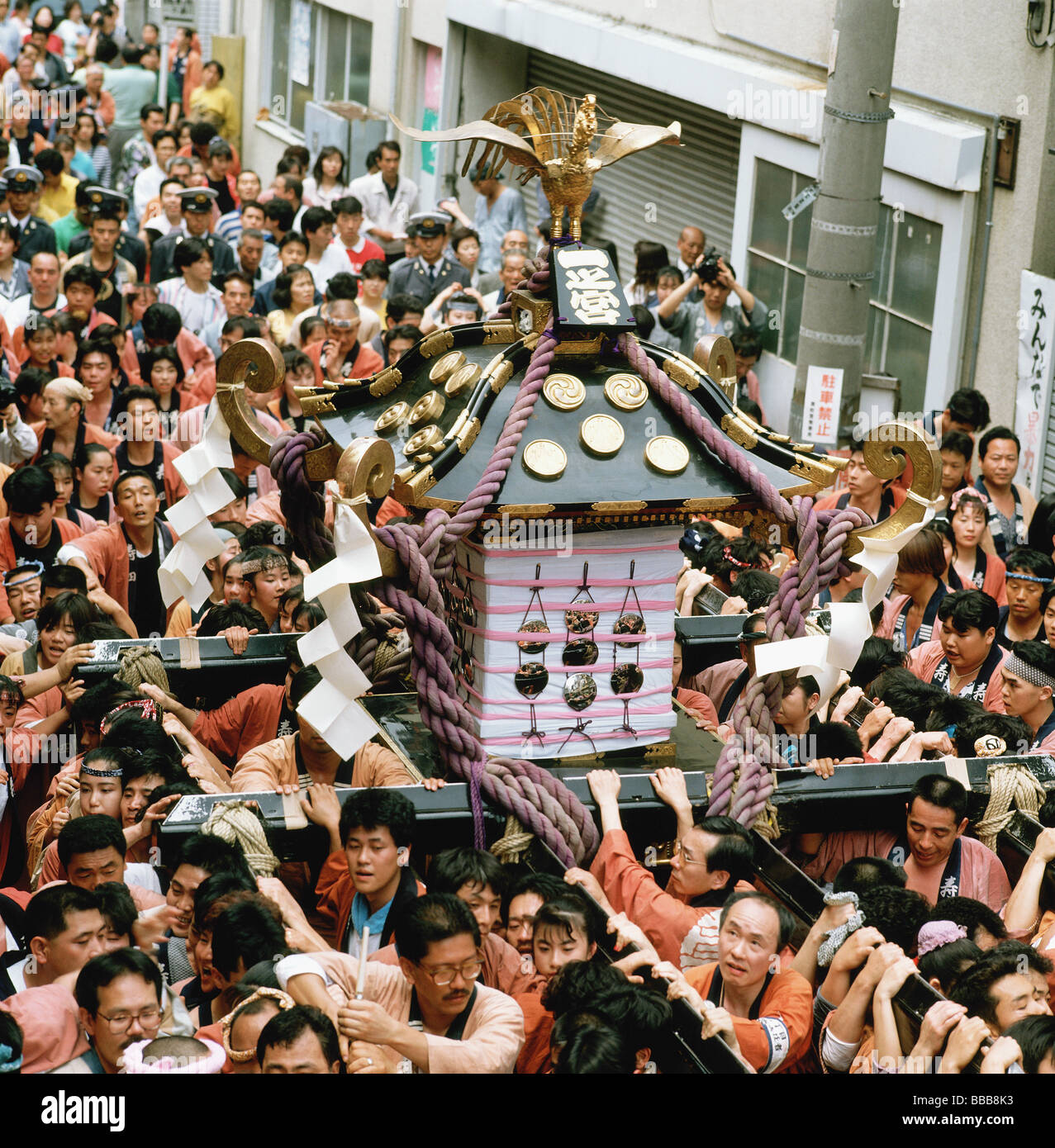 Japan, Tokyo, Portable shrine (mikoshi) is carried through the streets ...