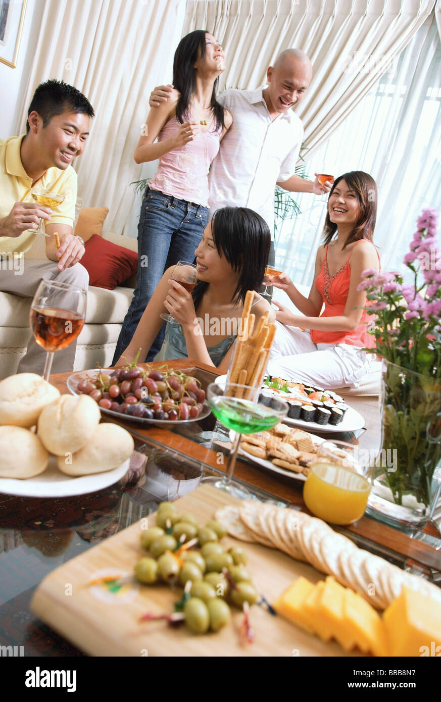 Adults in living room, having party Stock Photo - Alamy