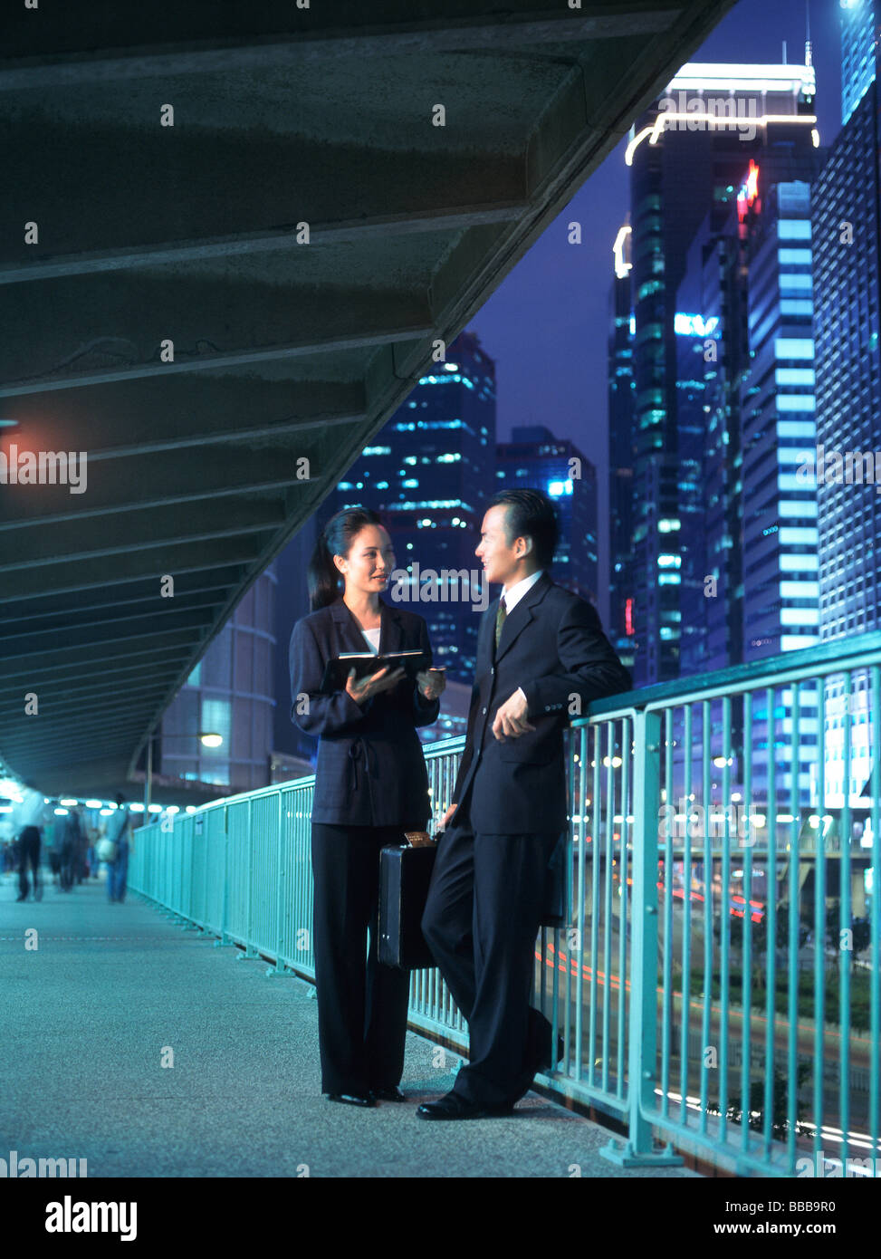 Two executives talking at night, skyline behind Stock Photo - Alamy