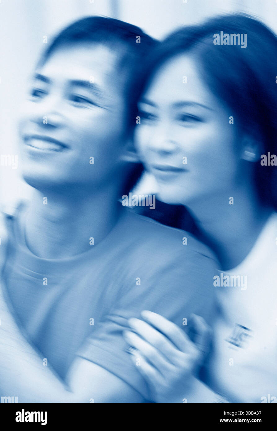 Couple looking off camera (motion blur Stock Photo - Alamy