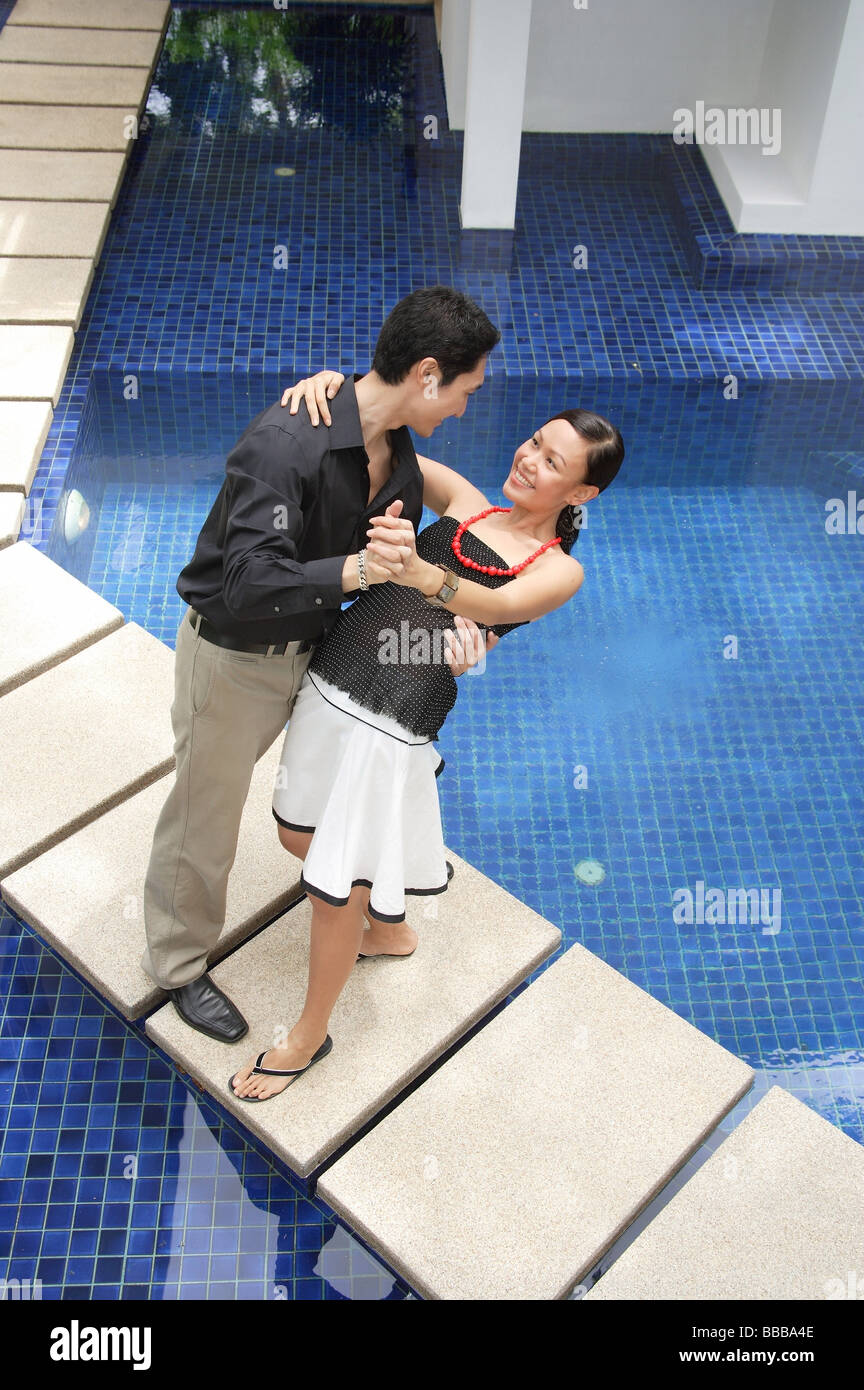 Couple dancing by swimming pool, man dipping woman Stock Photo - Alamy