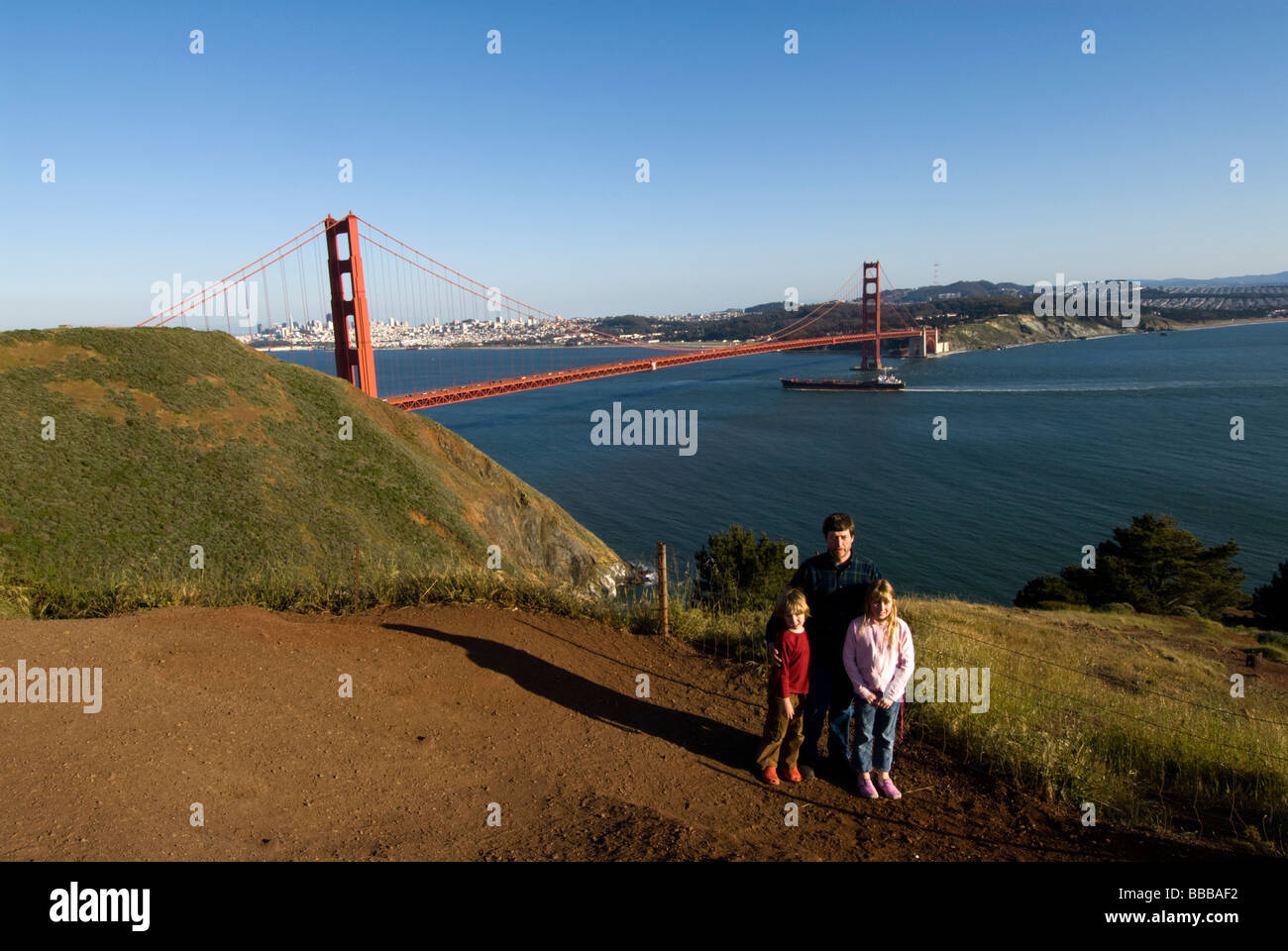 California Family of tourists overlooking Golden Gate Bridge; view of ...