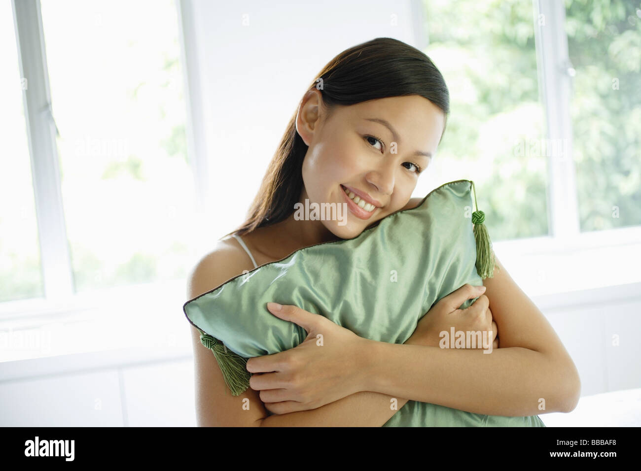 Woman hugging green cushion hi-res stock photography and images - Alamy
