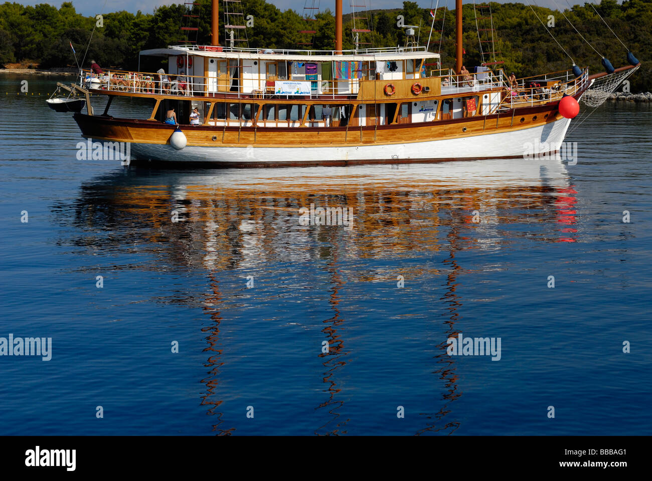 Charter boat at anchor in secluded bay in one of the small islands in ...