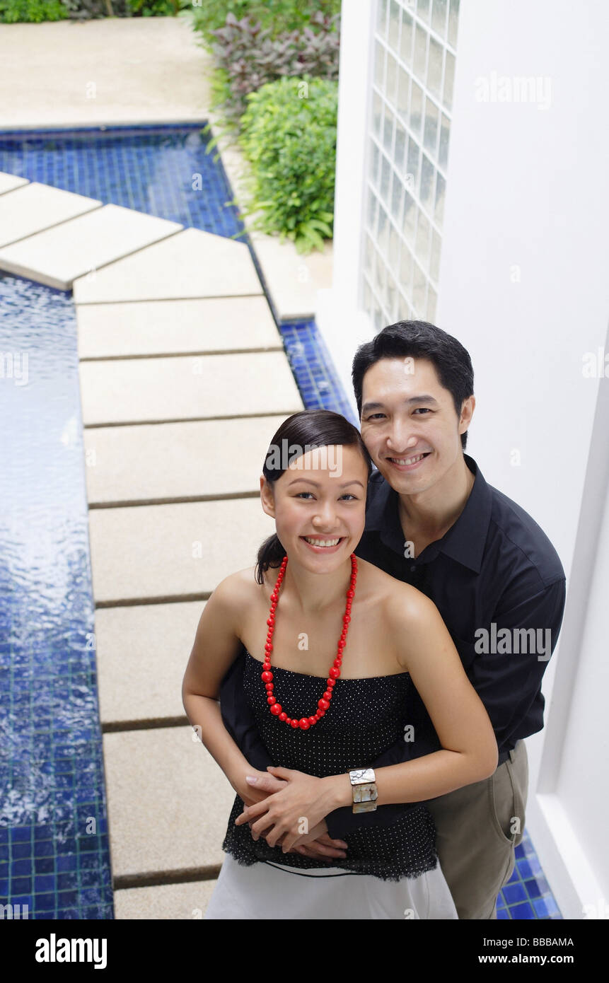 Man embracing woman, both smiling up at camera Stock Photo - Alamy