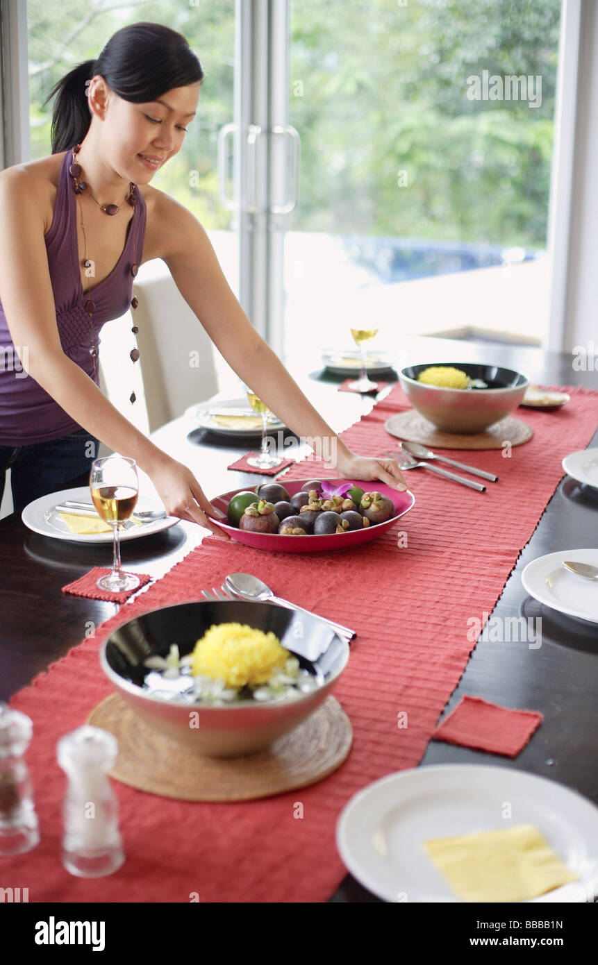 Young woman setting the dining table Stock Photo - Alamy