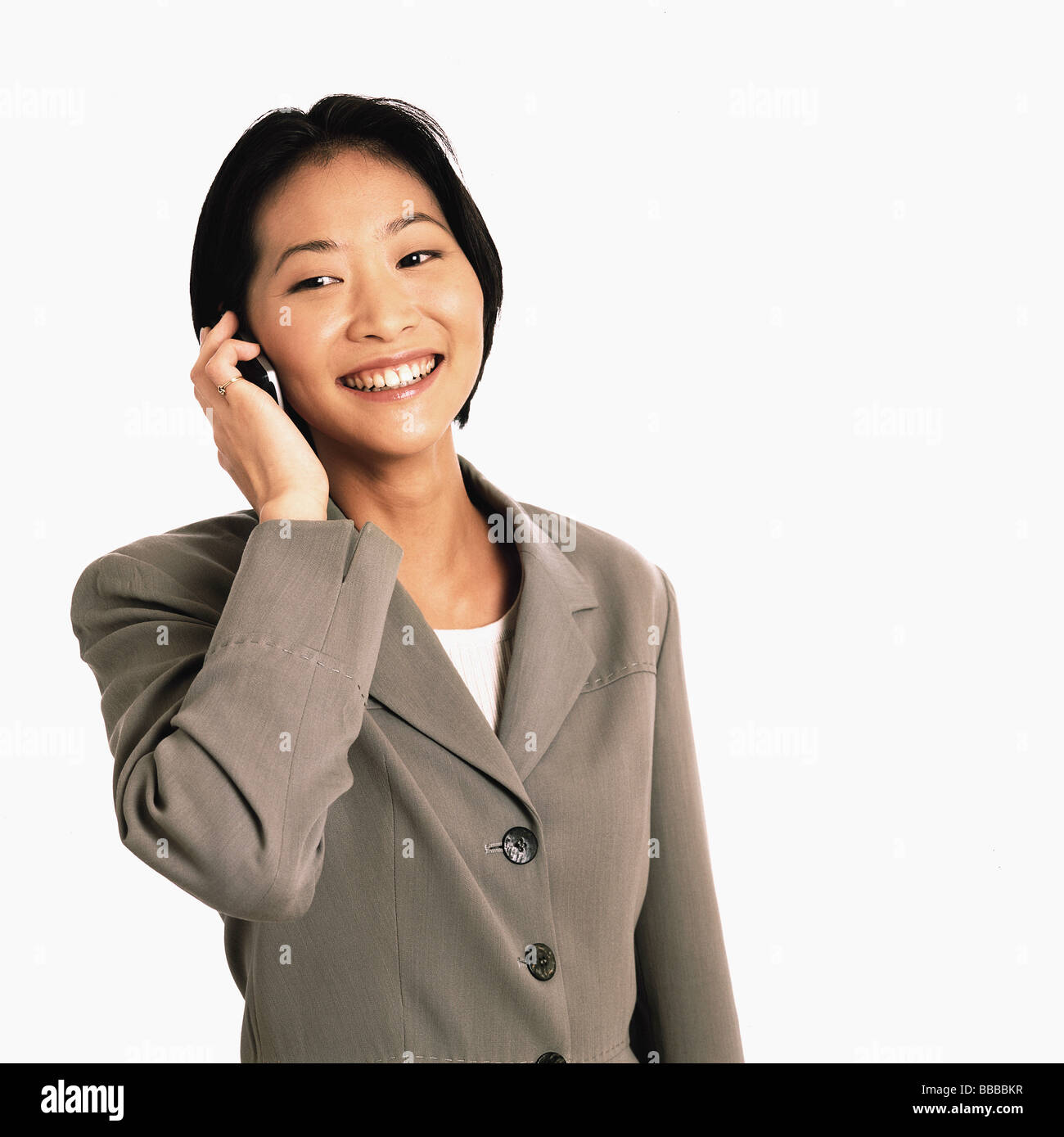 Female executive talking on cellular phone, white background Stock ...