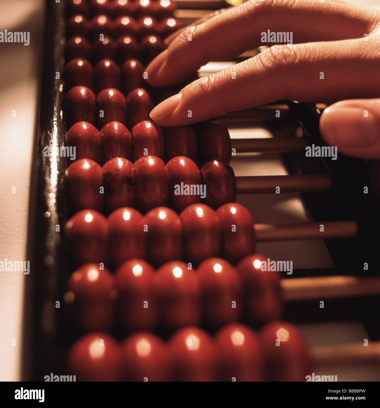 Fingers on an abacus Stock Photo - Alamy