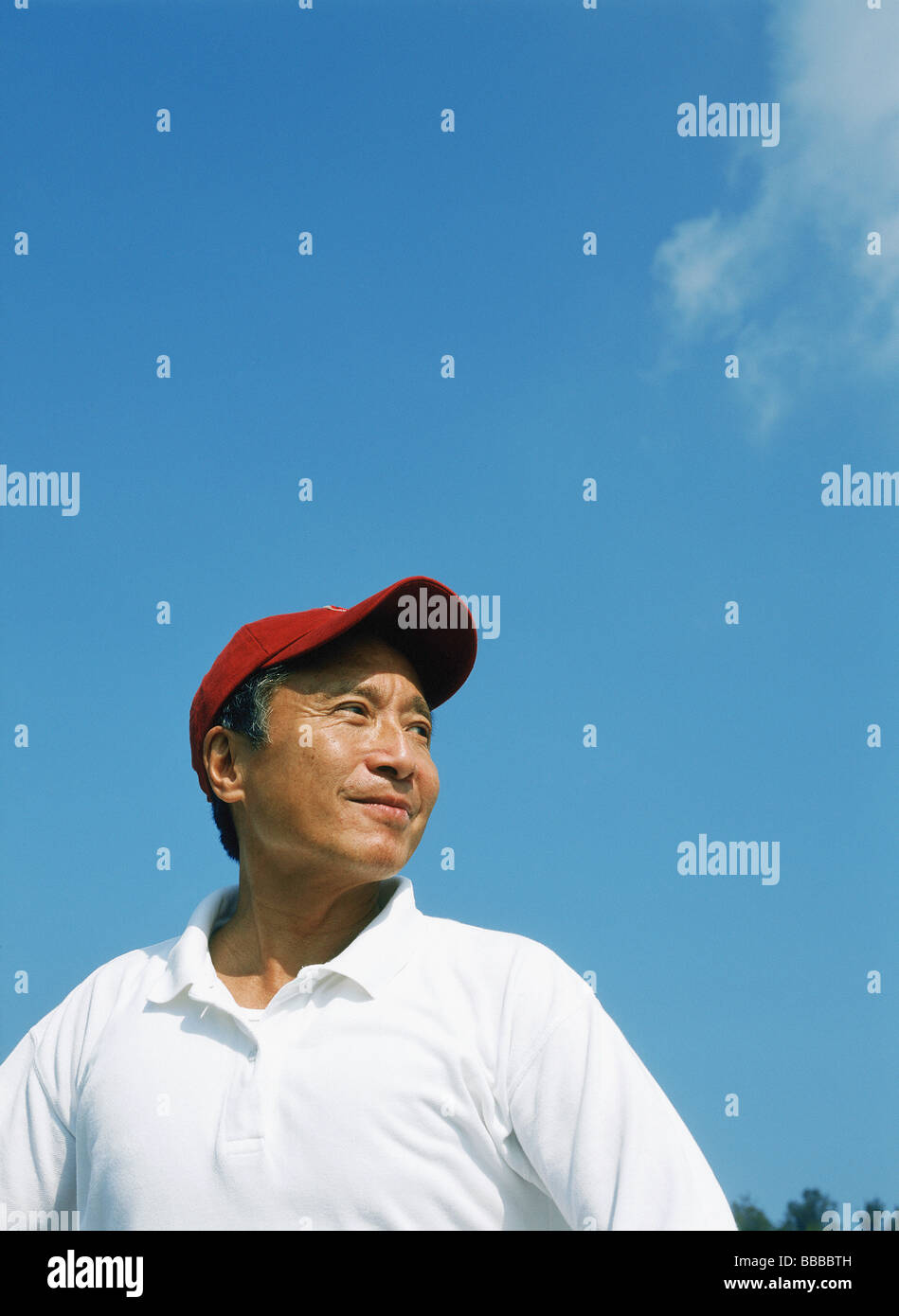 Mature man with red cap, outdoors, looking off camera Stock Photo - Alamy
