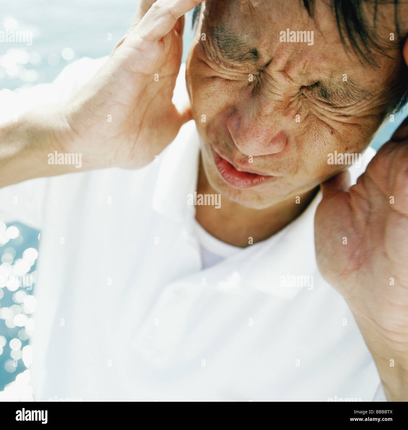 Man rubbing temples Stock Photo - Alamy