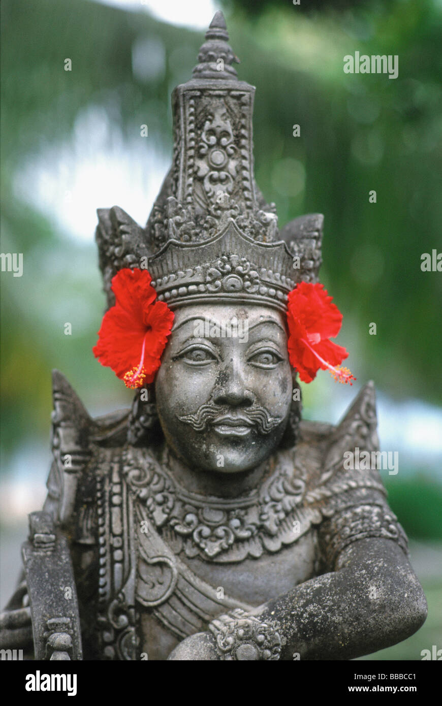 Indonesia, Bali, stone statue with flowers Stock Photo - Alamy