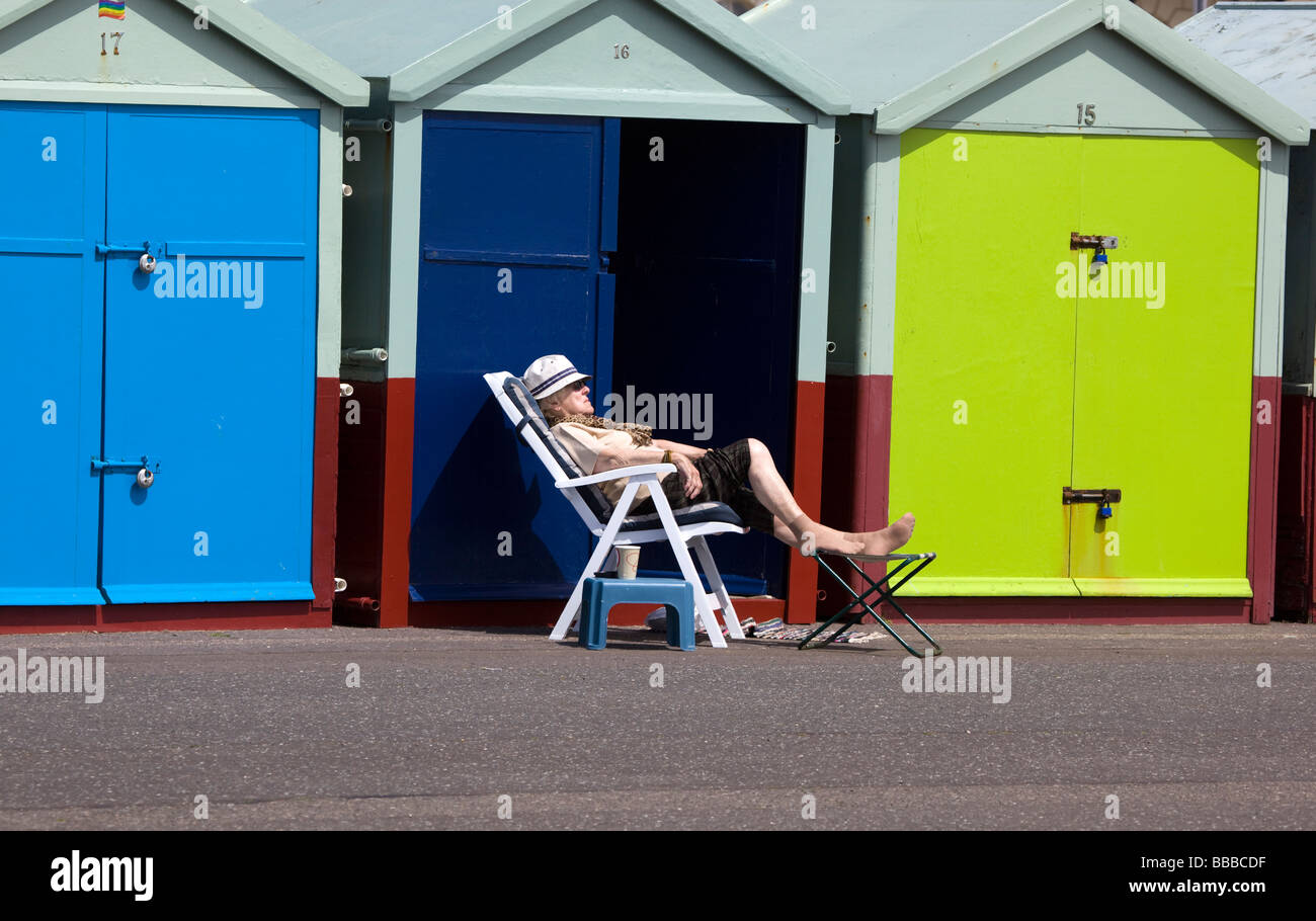 Woman relaxing outside her Beach Hut Hove Brighton England Stock Photo ...