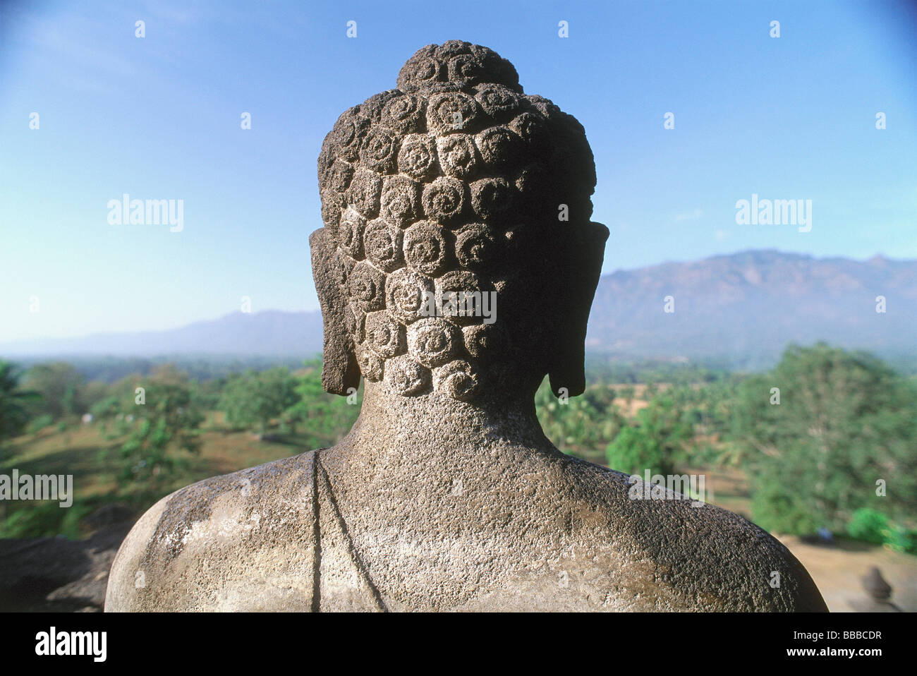 Indonesia, Java, Buddha figure at Borobudur temple, mountains in ...