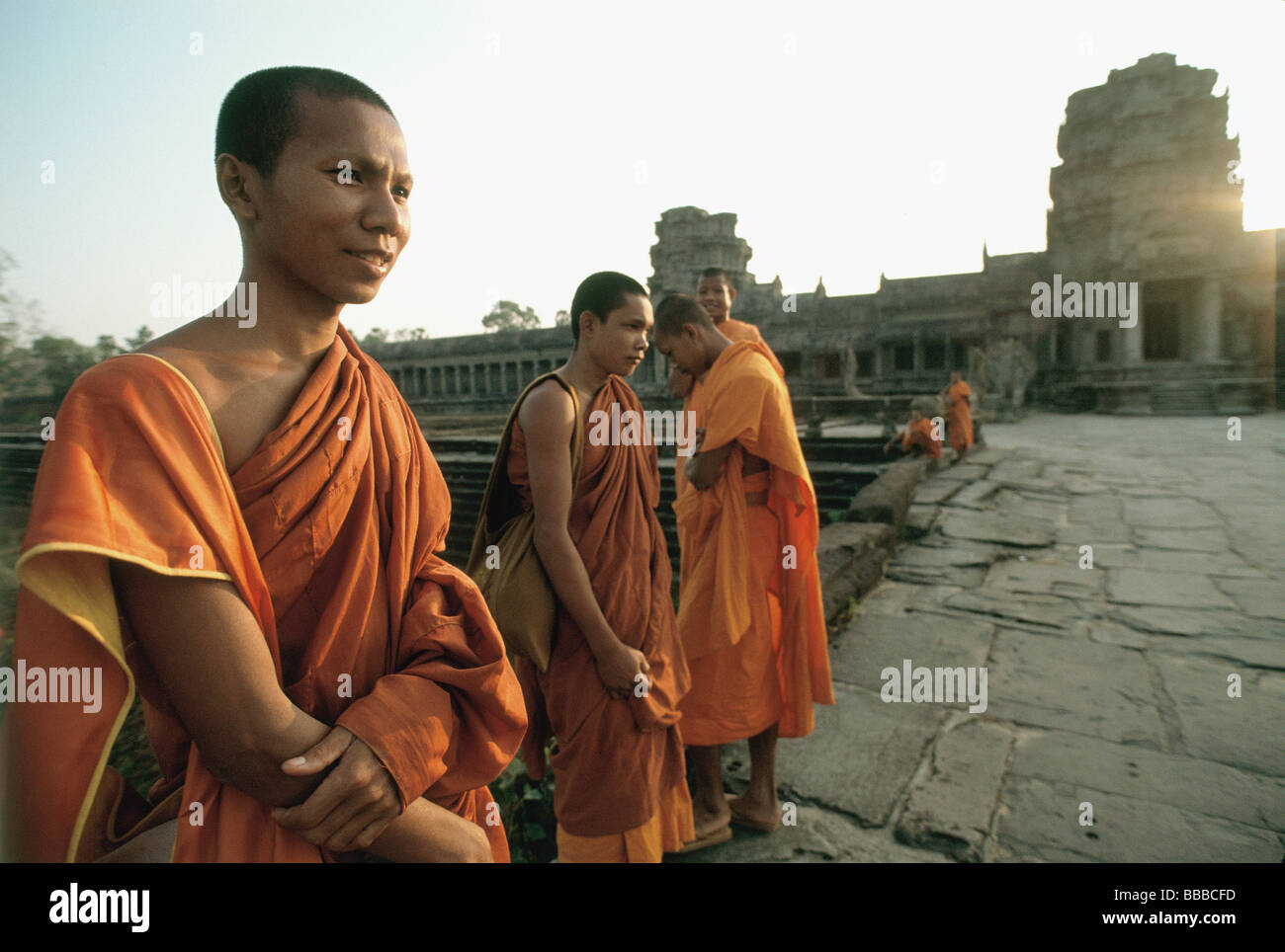 Cambodia, Angkor Wat, Young monks on stone path to temple Stock Photo ...