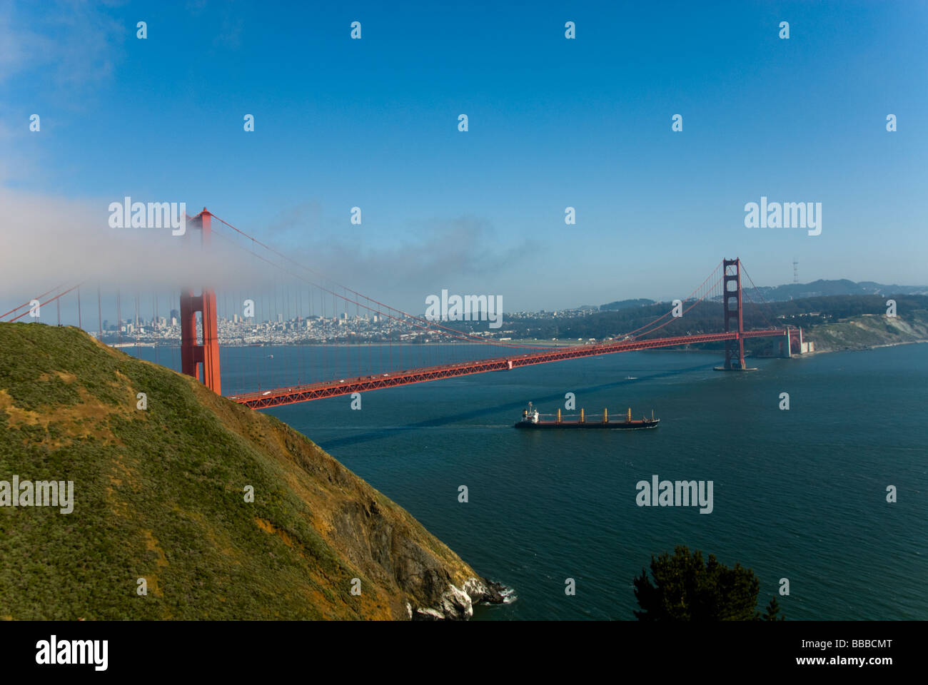 California Container ship passing under Golden Gate Bridge; view of ...