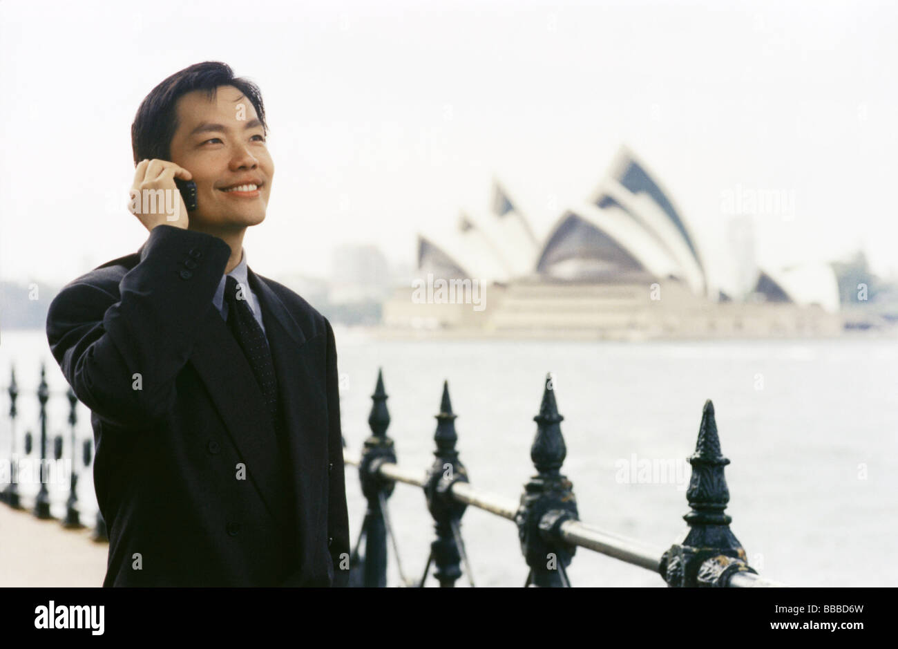 Executive using cellular phone, Sydney Opera House in background Stock ...