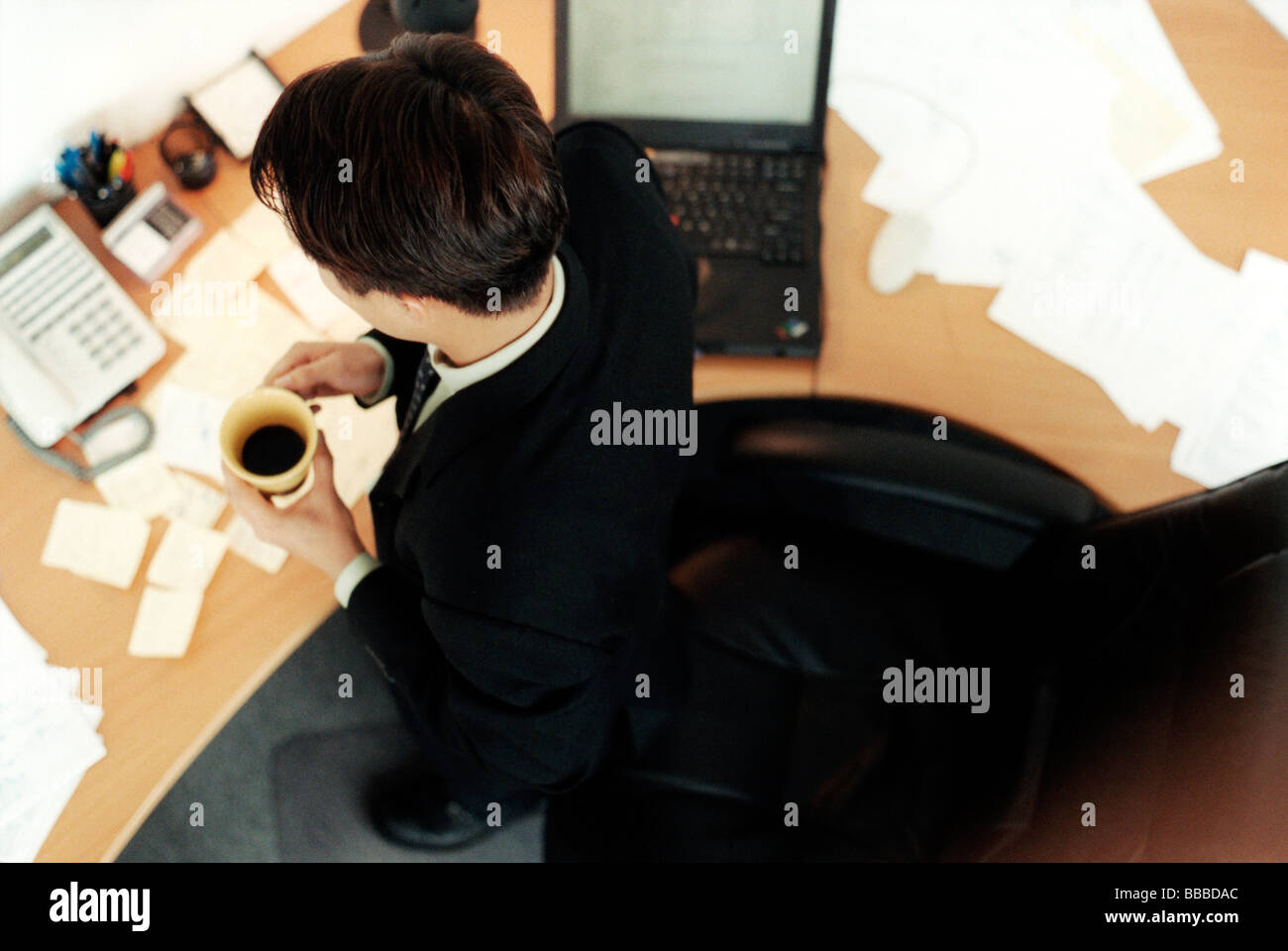 Male executive sitting at desk, top view Stock Photo - Alamy