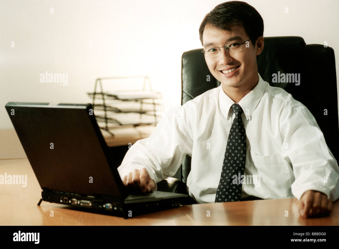 Male executive at desk with laptop Stock Photo - Alamy