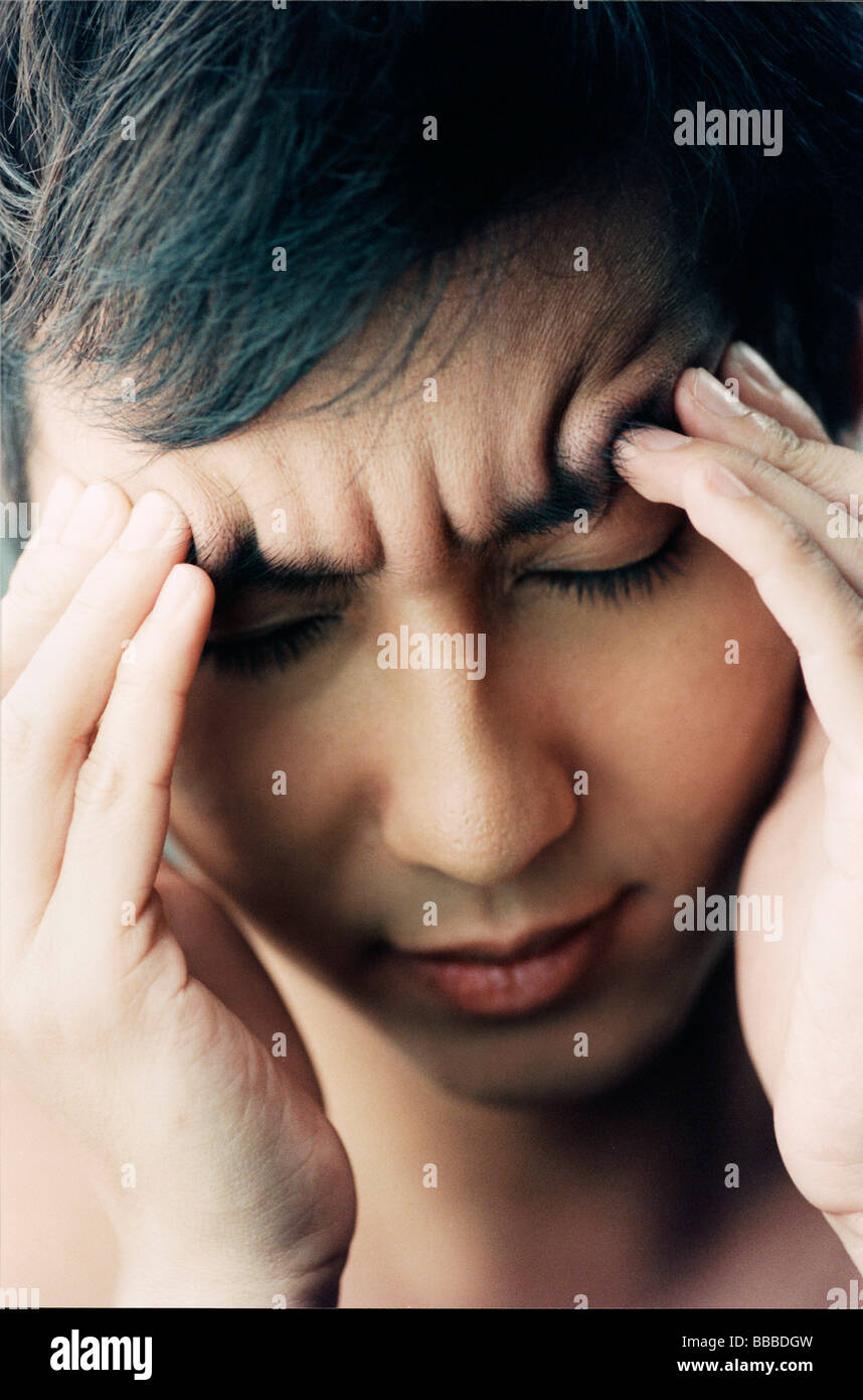 Man with worried expression, fingers on temples Stock Photo - Alamy