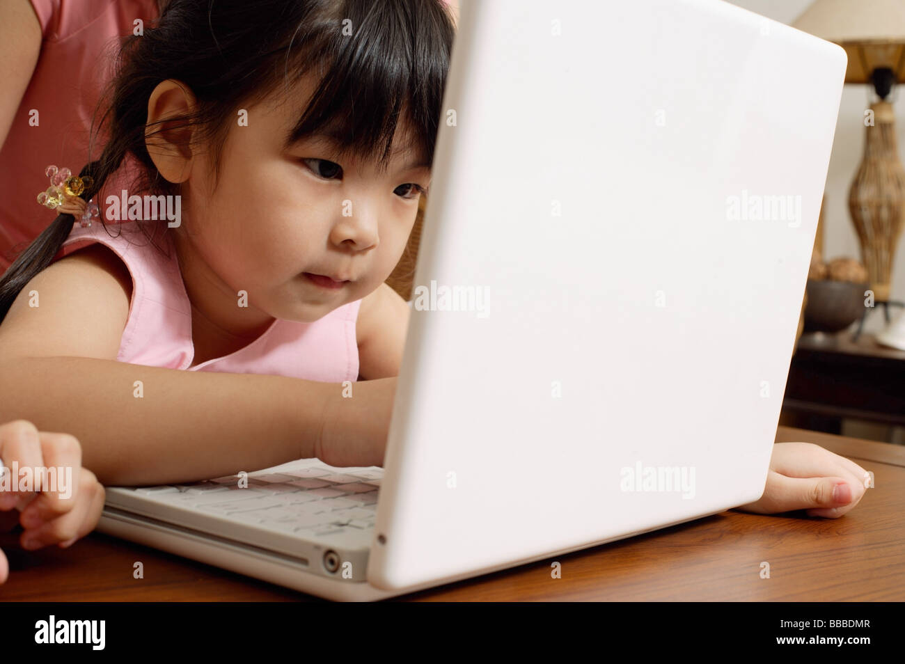 Little girl using laptop Stock Photo - Alamy
