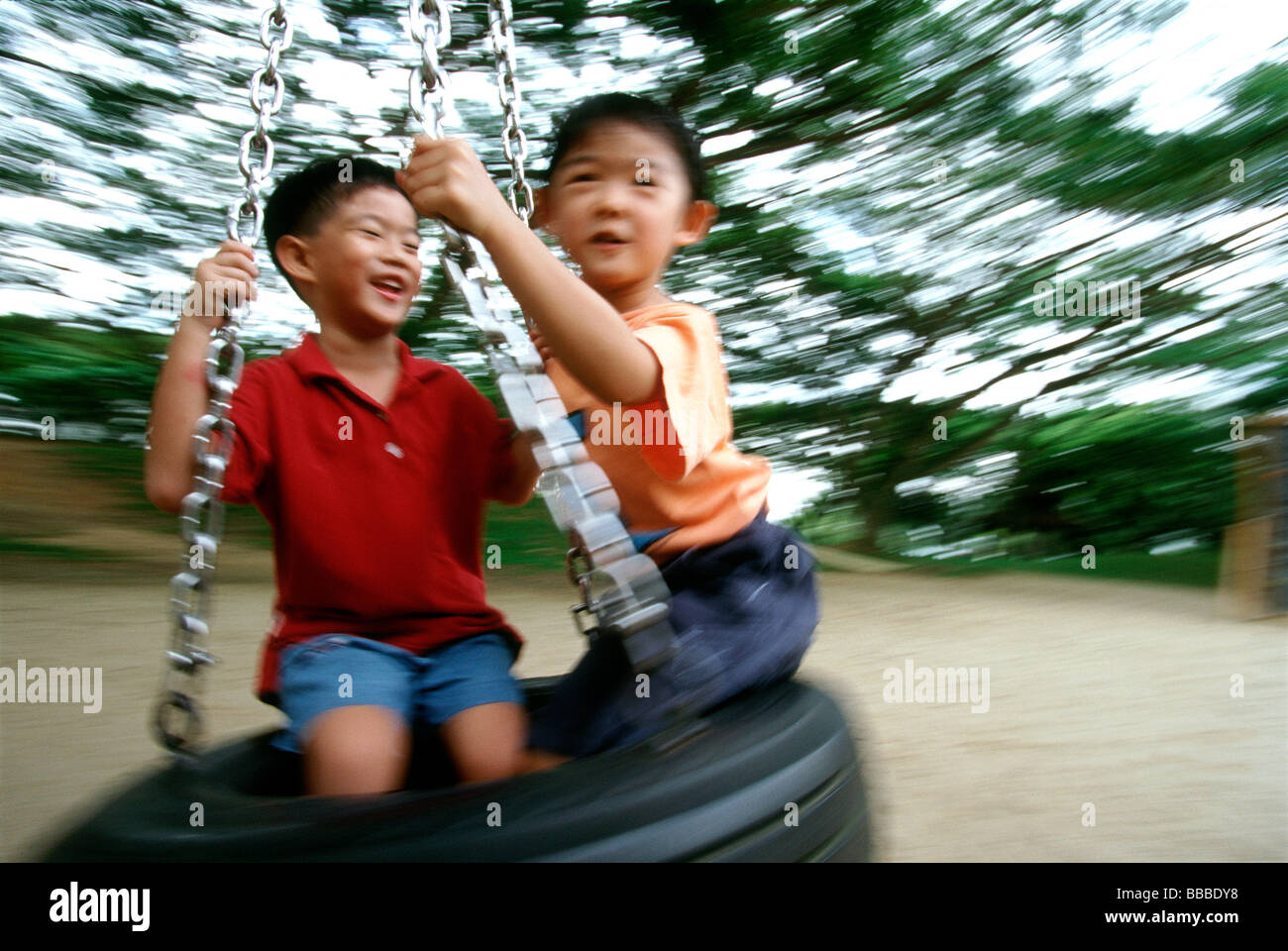 Two boys playing on a swing hi-res stock photography and images - Alamy