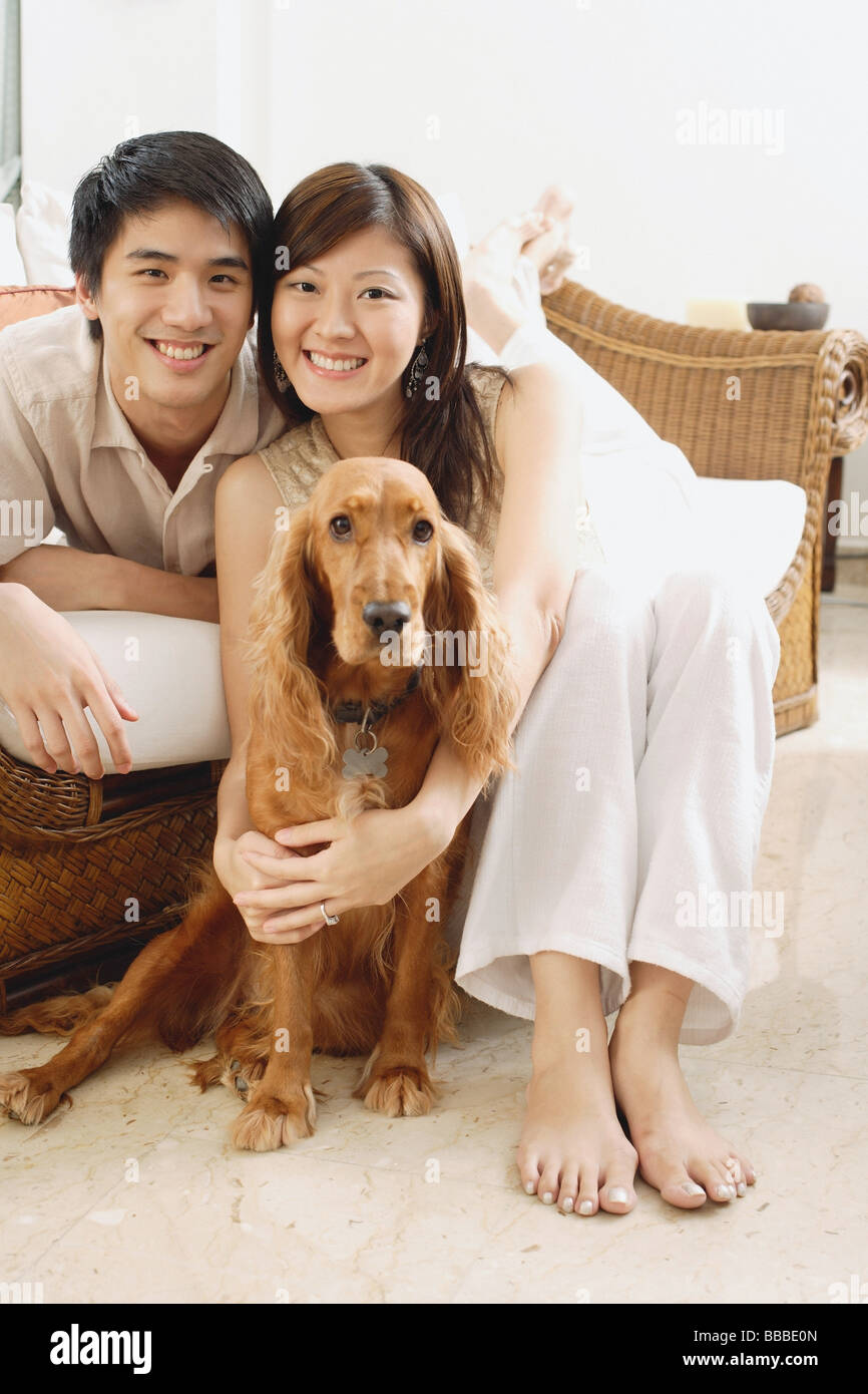 Couple in living room, with Cocker Spaniel dog Stock Photo - Alamy