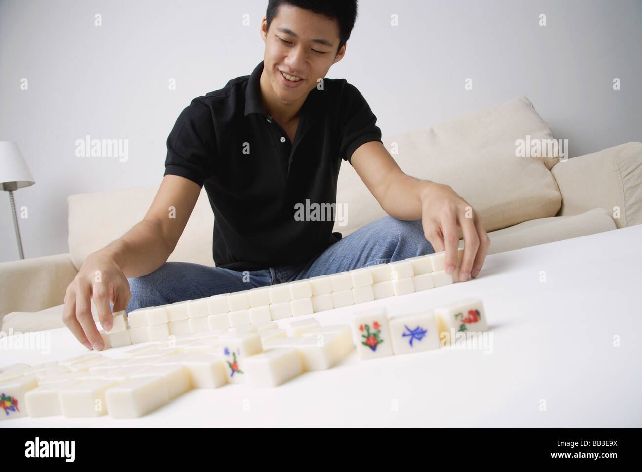 Man arranging mahjong tiles on the table Stock Photo - Alamy