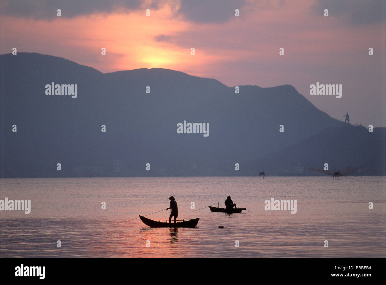 Vietnam, Quy Nho'n, boats in the South China Sea at sunset Stock Photo ...