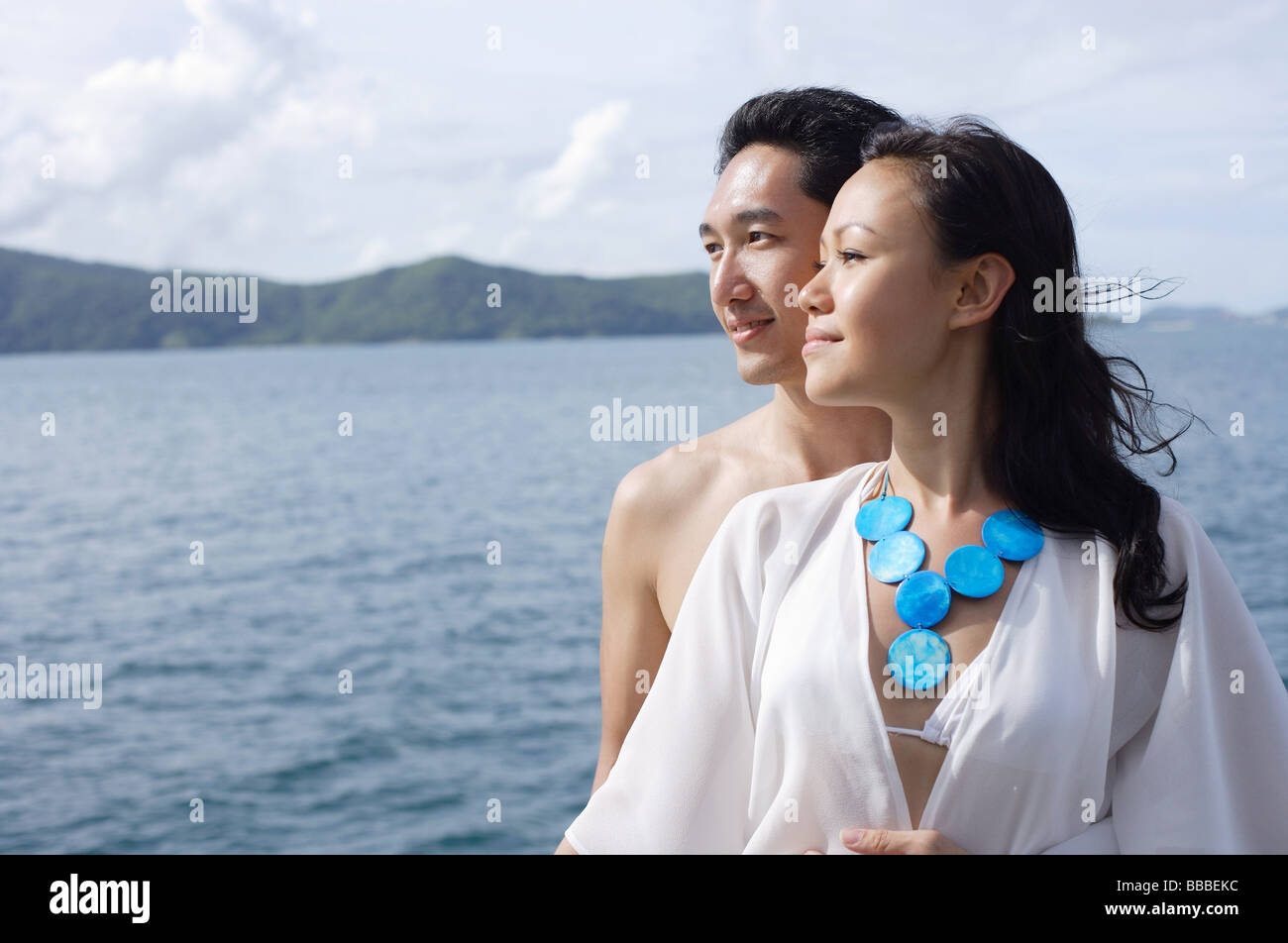 Couple standing together, cheek to cheek, looking away Stock Photo - Alamy