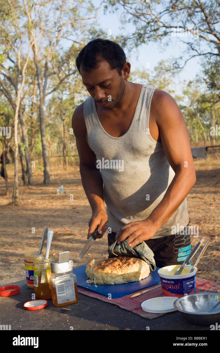 A guide serves up damper - a camp style bread - on a camping safari in ...