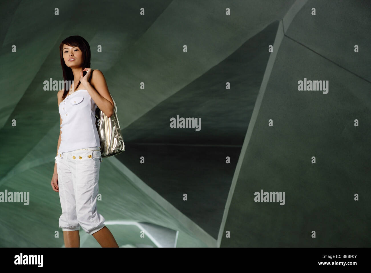 Woman carrying bag over shoulder Stock Photo - Alamy