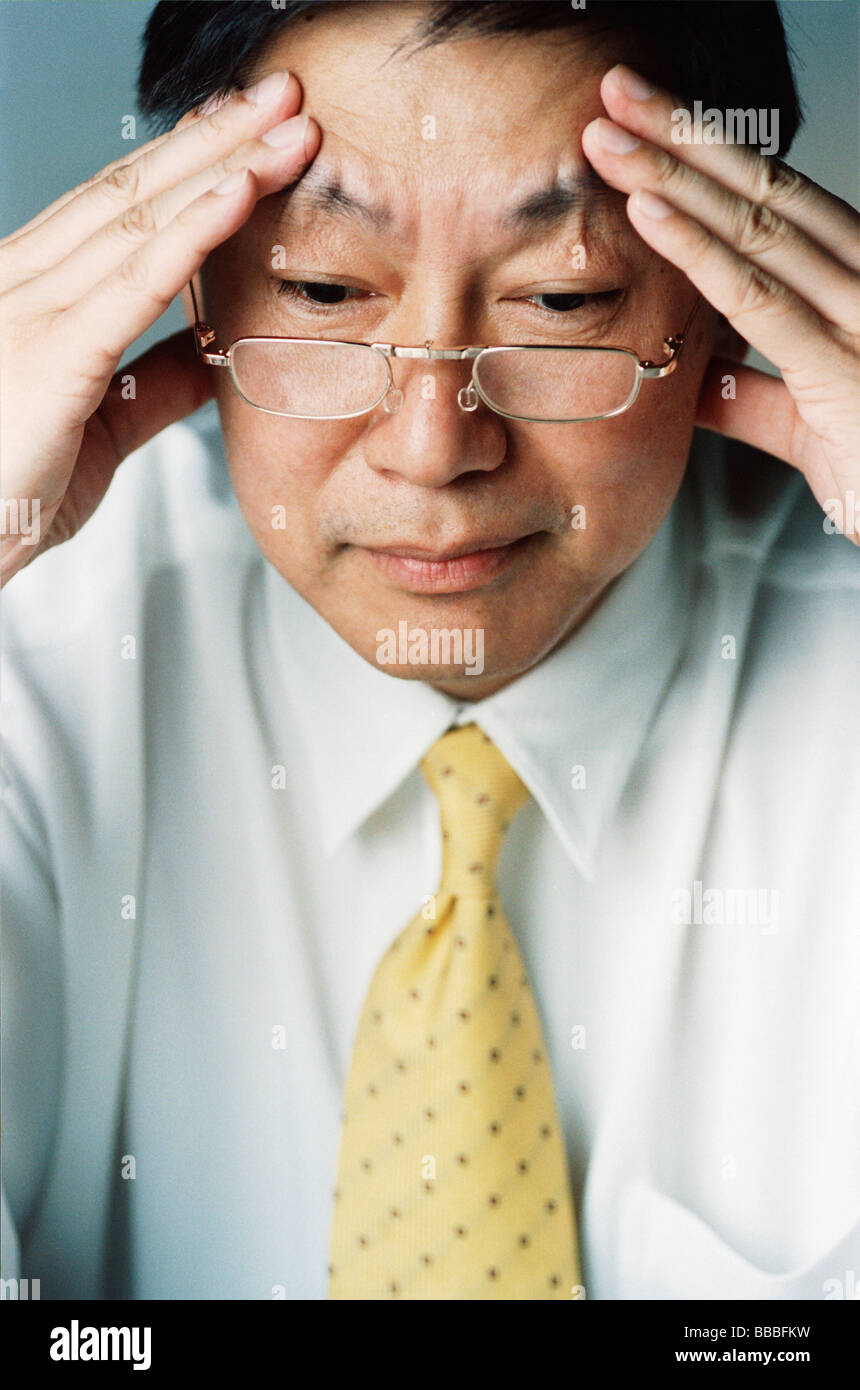 Mature man rubbing temples hi-res stock photography and images - Alamy